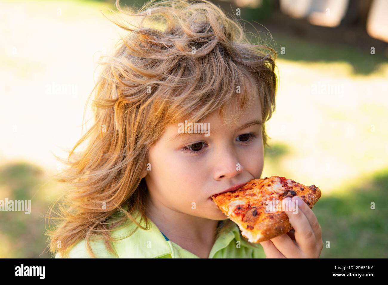 Kid boy eating pizza outdoor. Pizza the best food. Cute little child ...