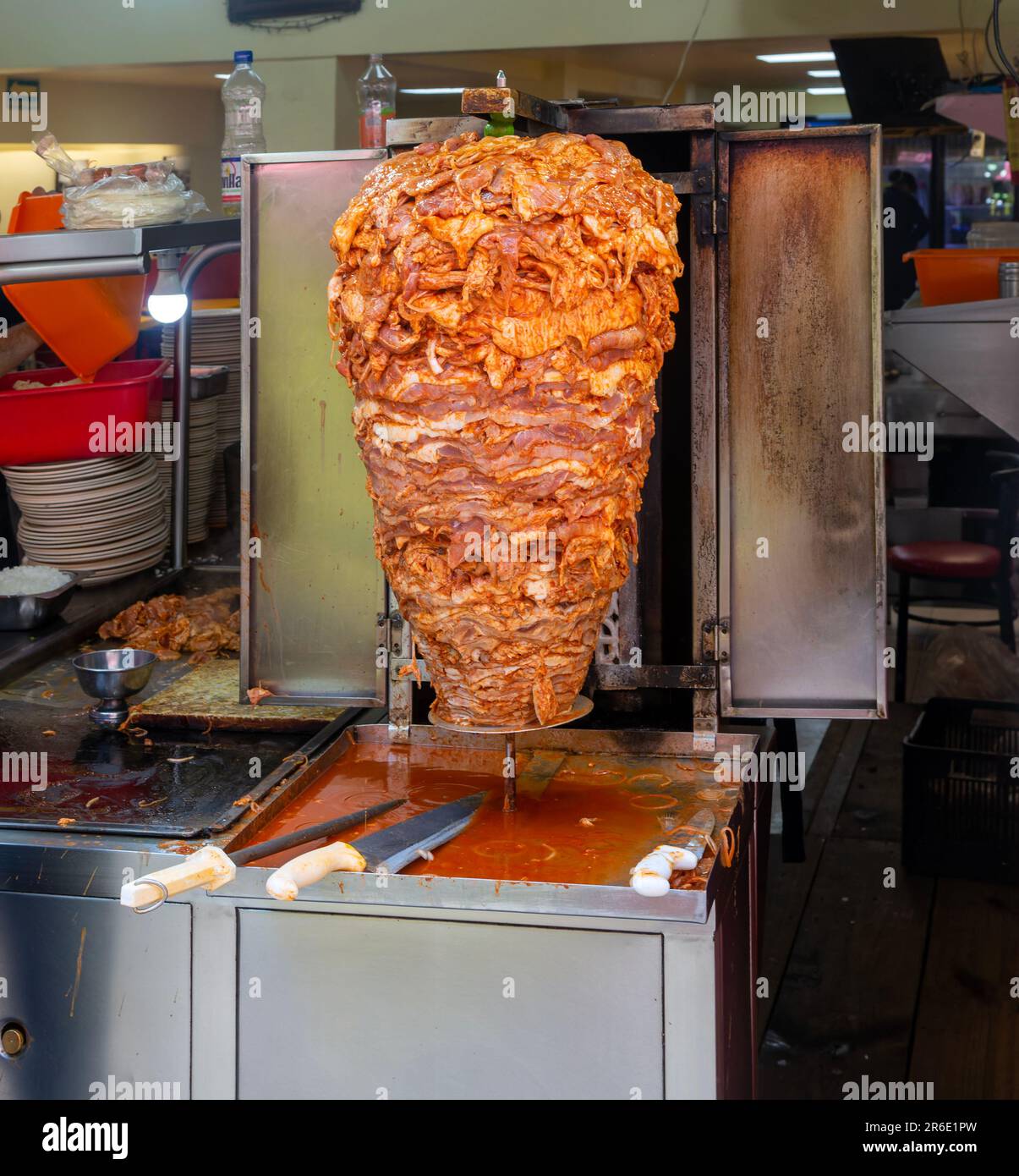 Meat grilling on vertical kebab spit in fast food street restaurant ...