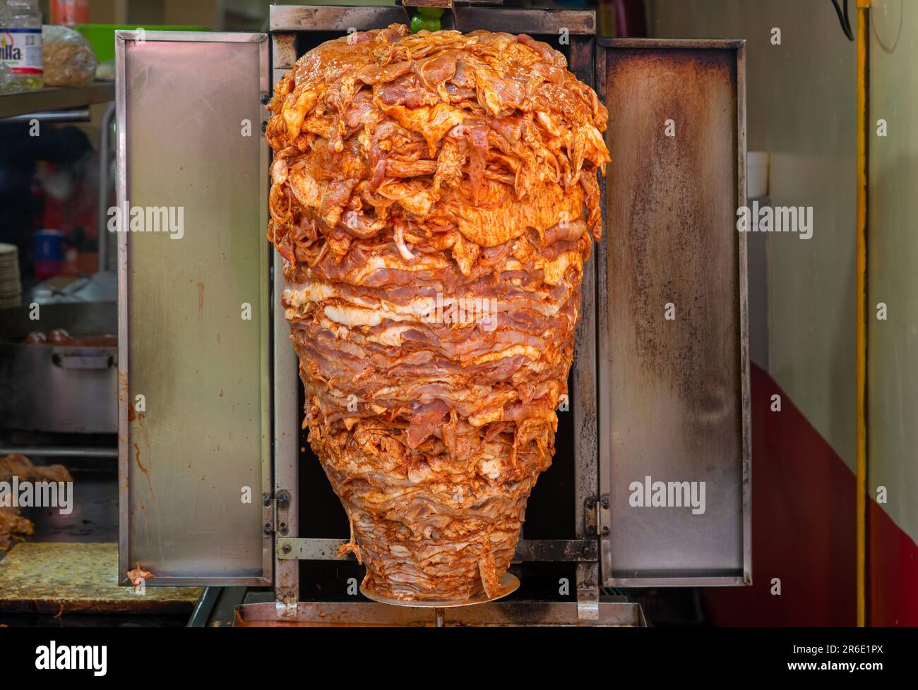 Meat grilling on vertical kebab spit in fast food street restaurant ...