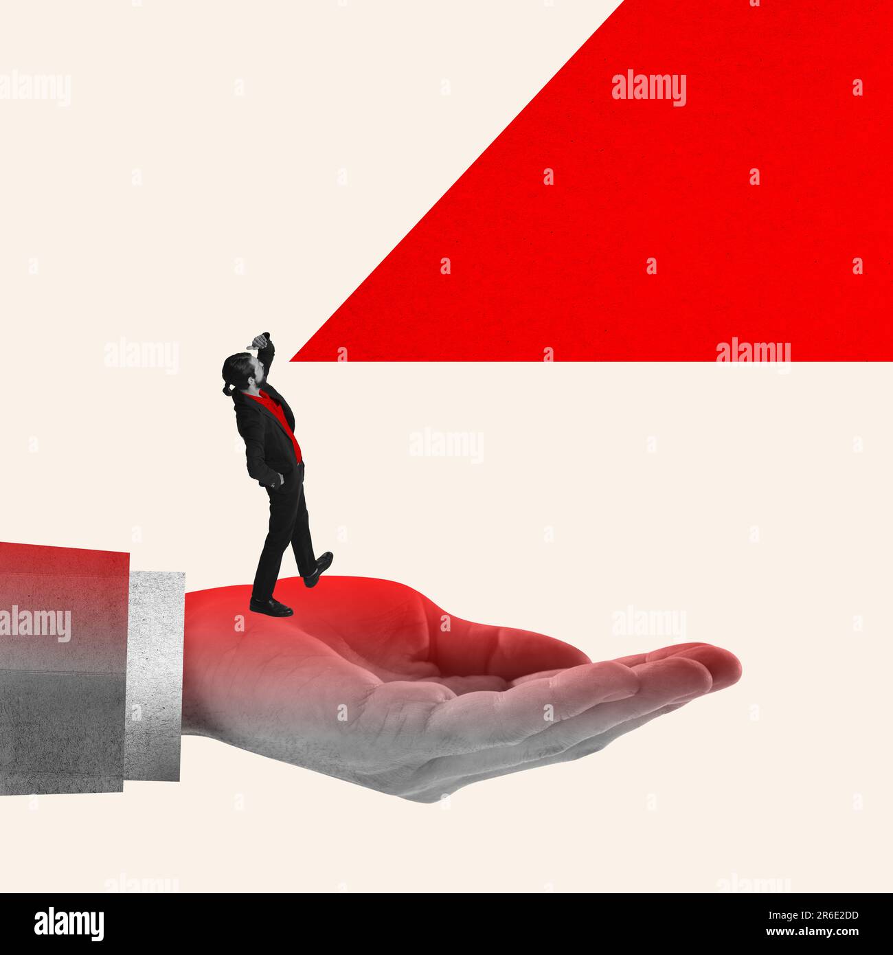 Male employee standing on giant hand and looking forward. Professional ...