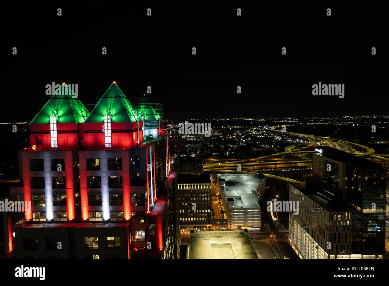 An aerial view of the skyline of Orlando at night, illuminated by ...