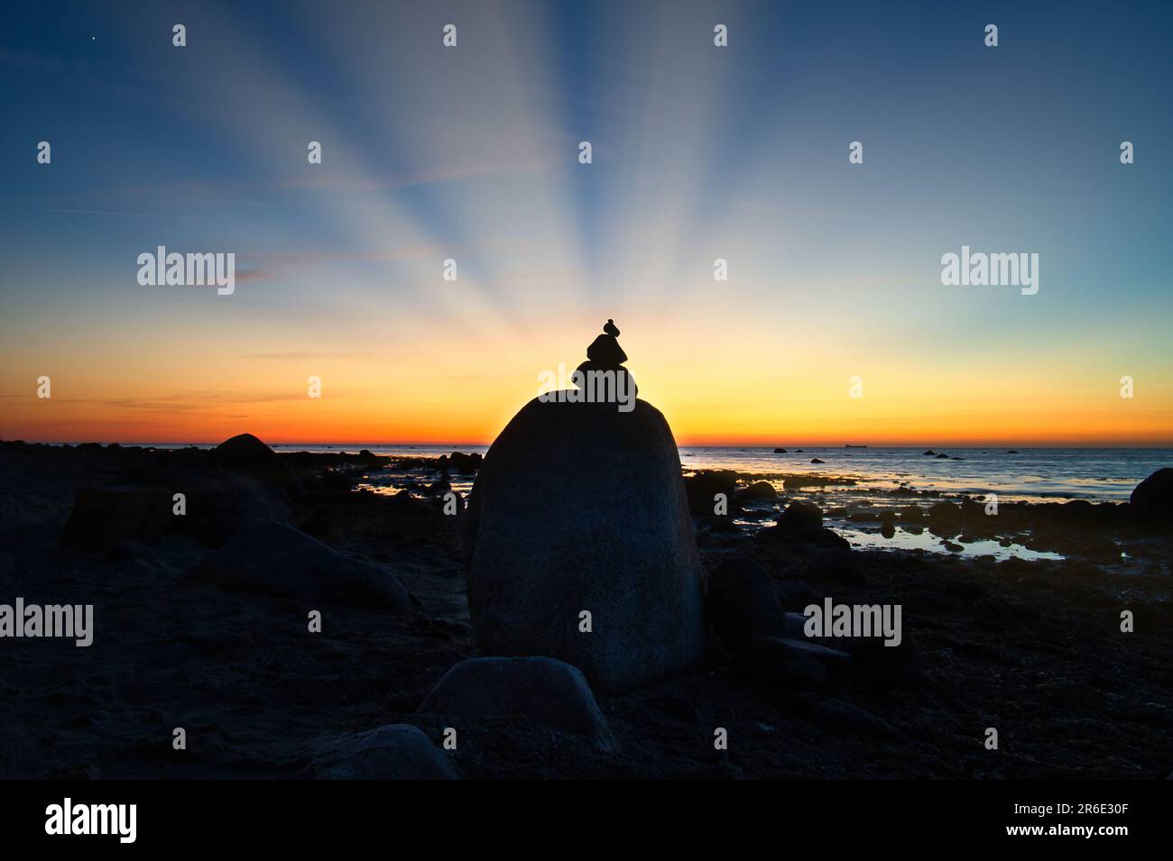 Stone pyramid on the Baltic Sea overlooking the sea at sunset. Sun ...