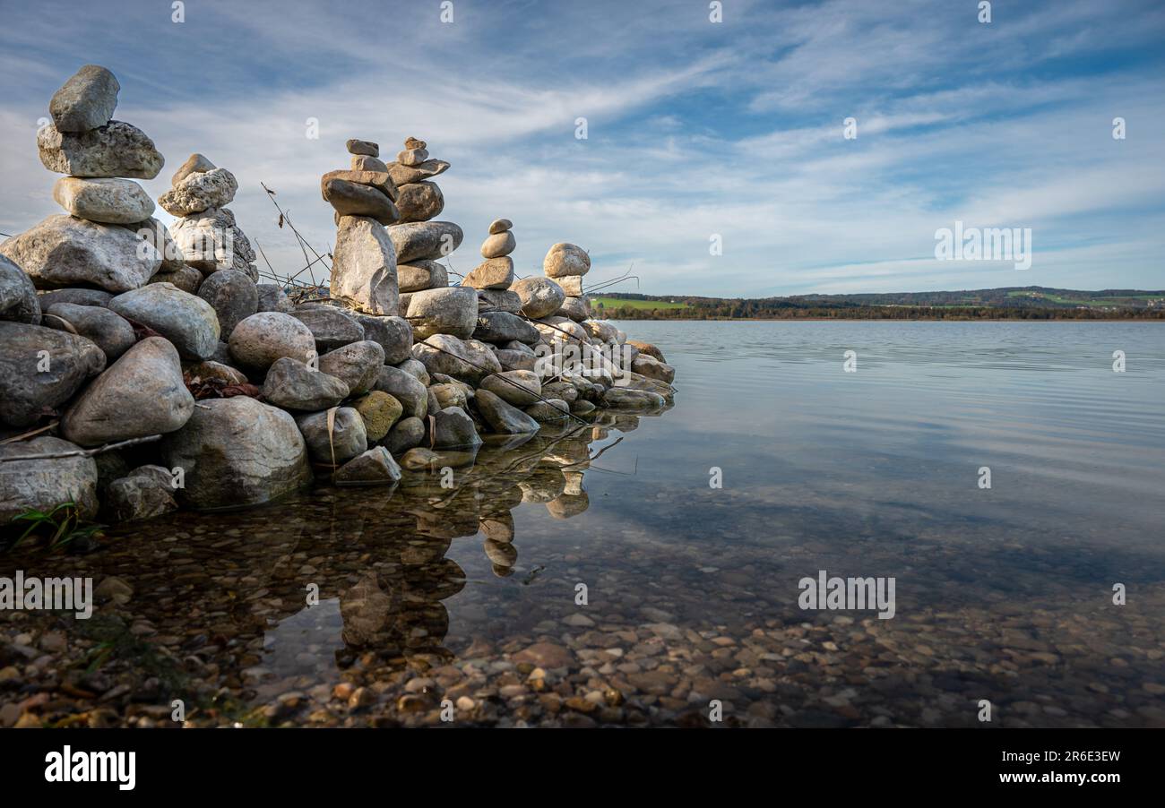 The natural rocks stacked up on the lakeshore against a backdrop of ...