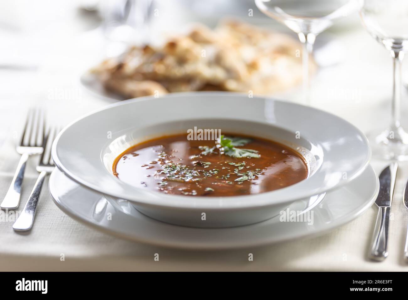 Plate of Italian minestrone soup with a fancy serving in a restaurant ...