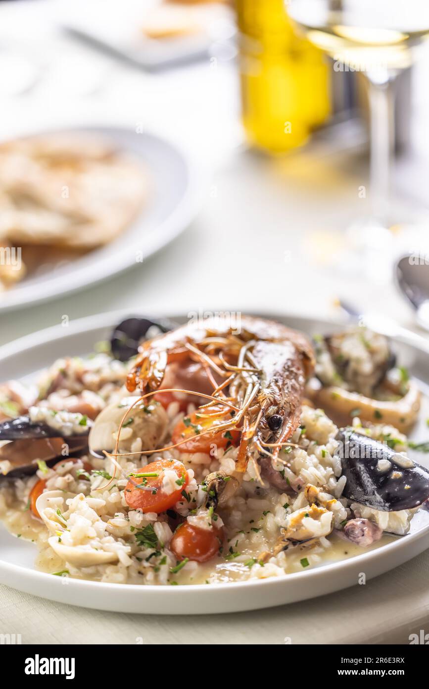 Detail of a seafood risotto made the Italian way and served on a ...