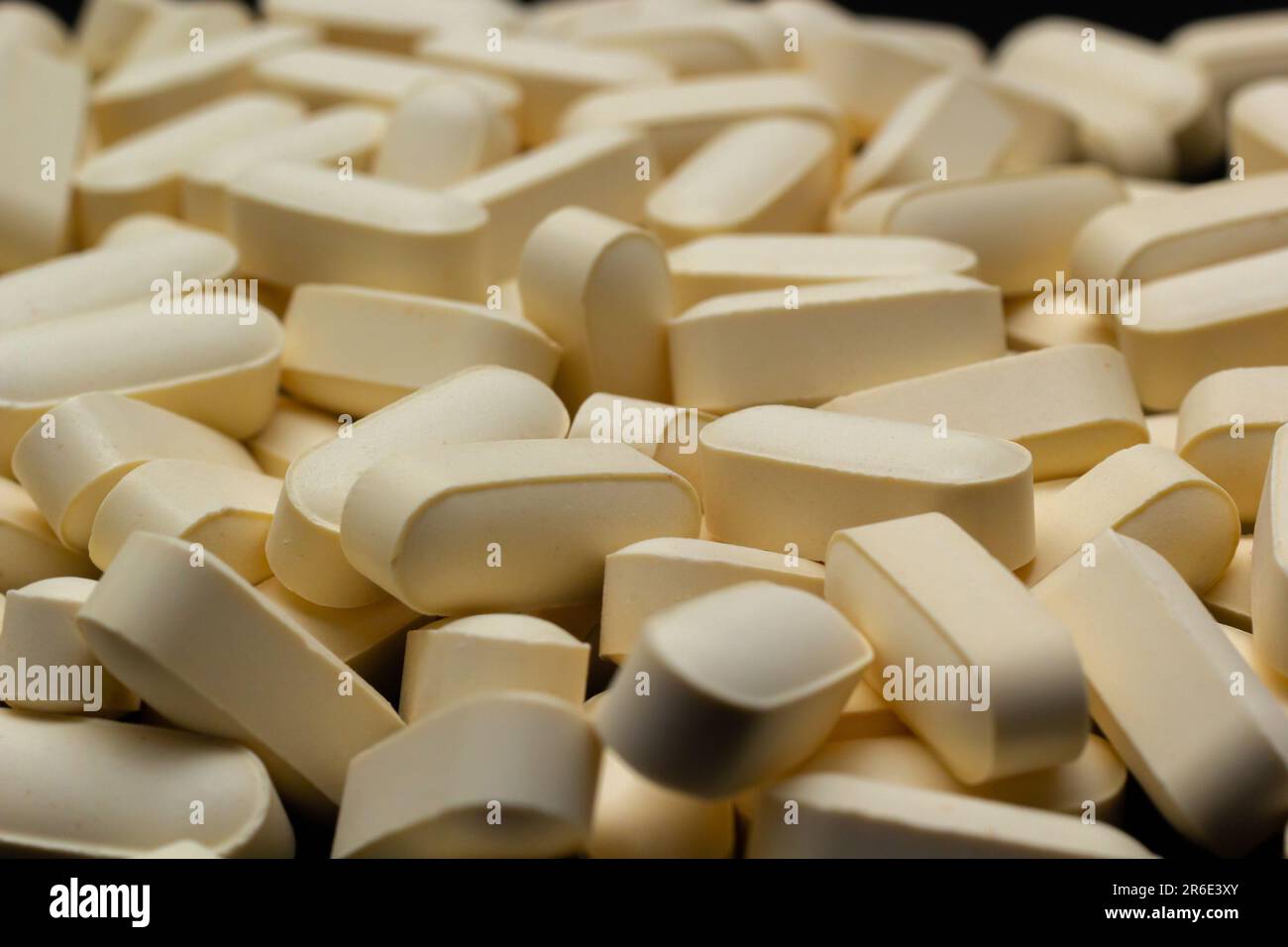 White capsules, pills on a black background. Medicine, healthcare ...