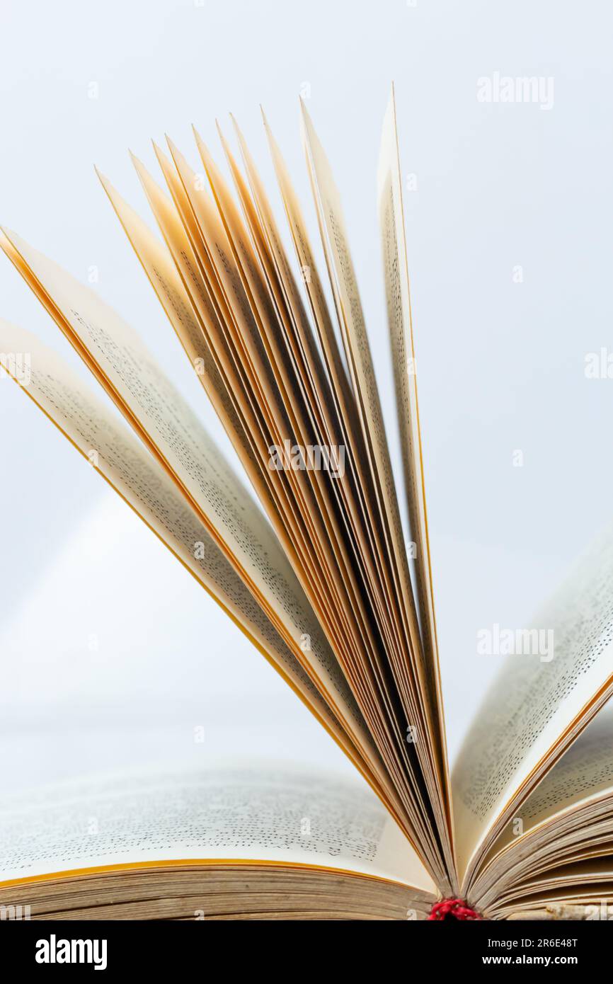 Open old book with text on white background. The concept of reading ...