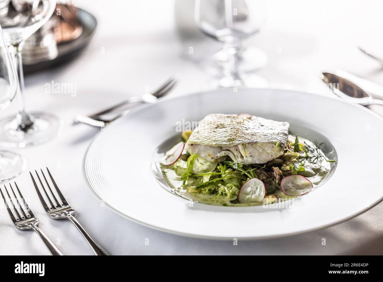 Cog fish served with green salad and wine dressing Stock Photo - Alamy