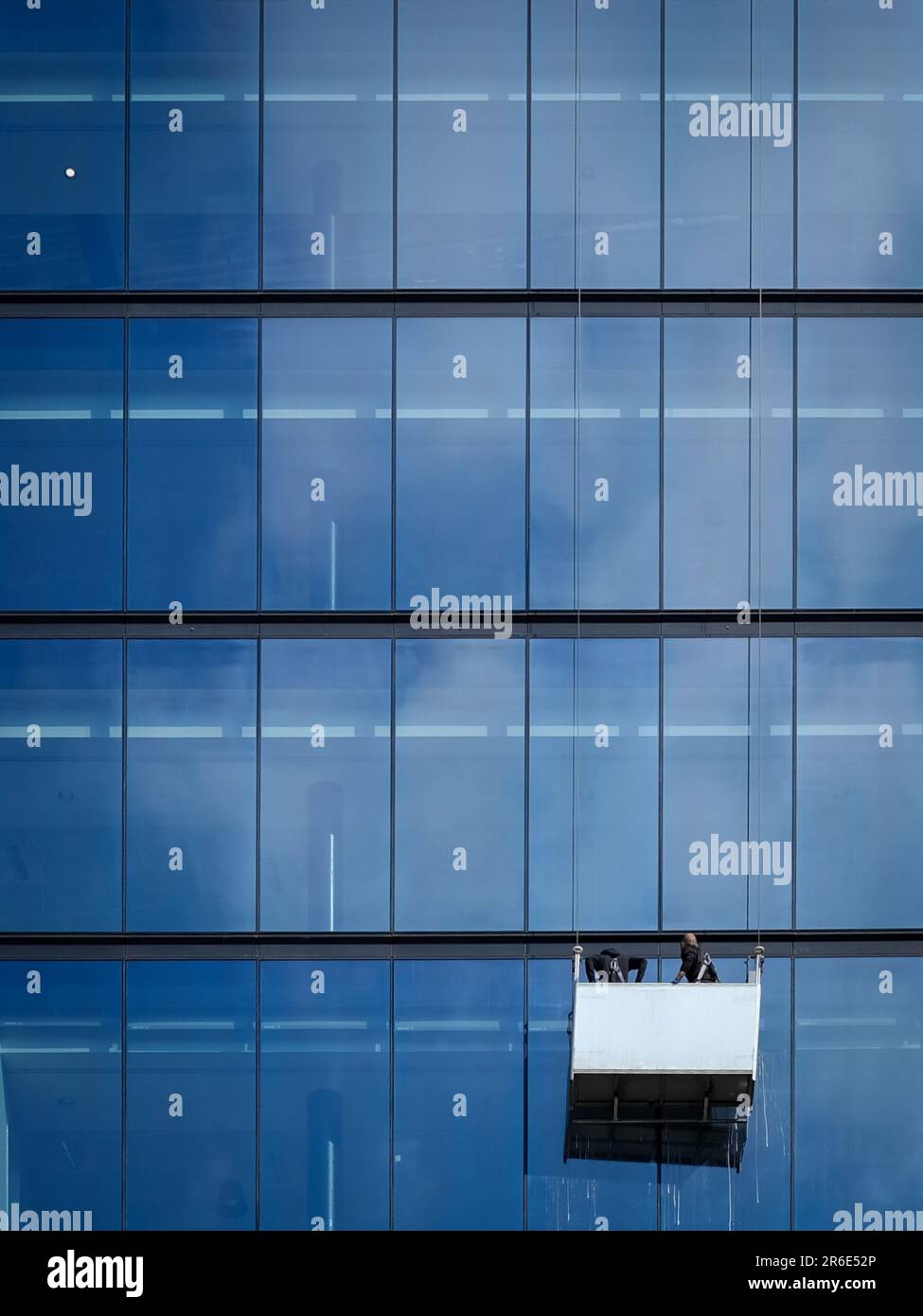 Professional high rise window cleaning service workers in gondola ...