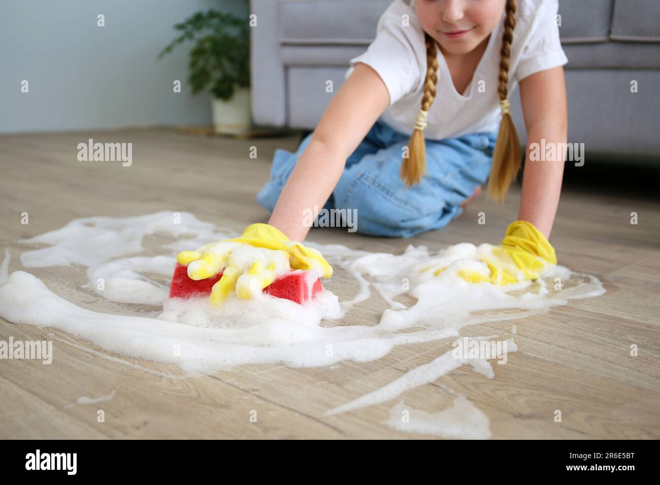 The child washes the floors of the house. The concept of child labor ...