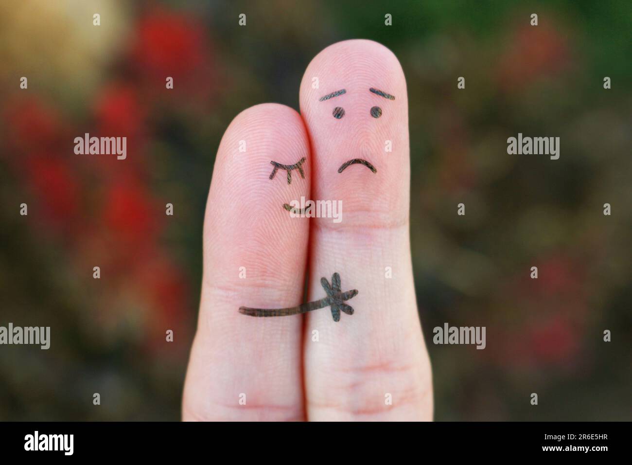 Fingers art of displeased couple. Man is sad, woman reassures her. She ...