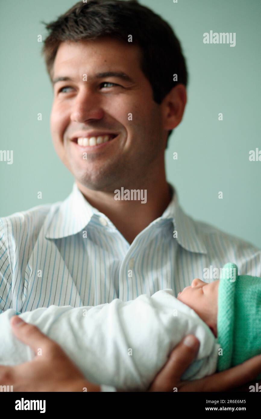 A father holds his new born daughter the day after she was born Stock ...