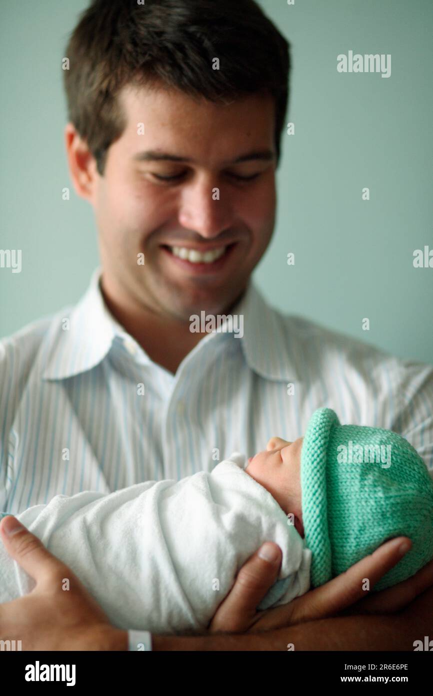 A father holds his new born daughter the day after she was born Stock ...