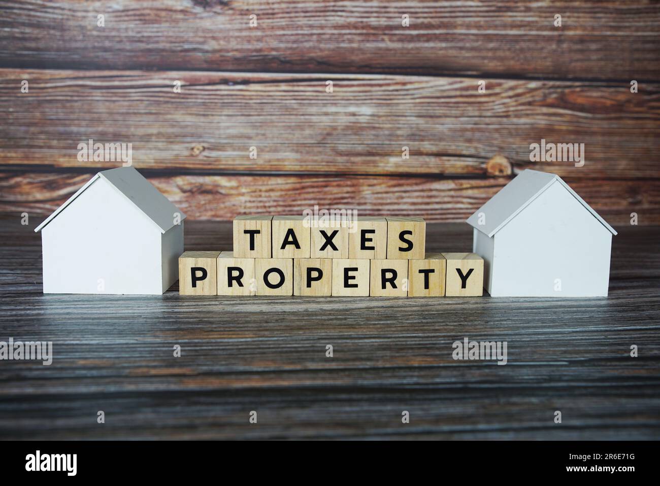Property Taxes alphabet letter with house model on wooden background ...