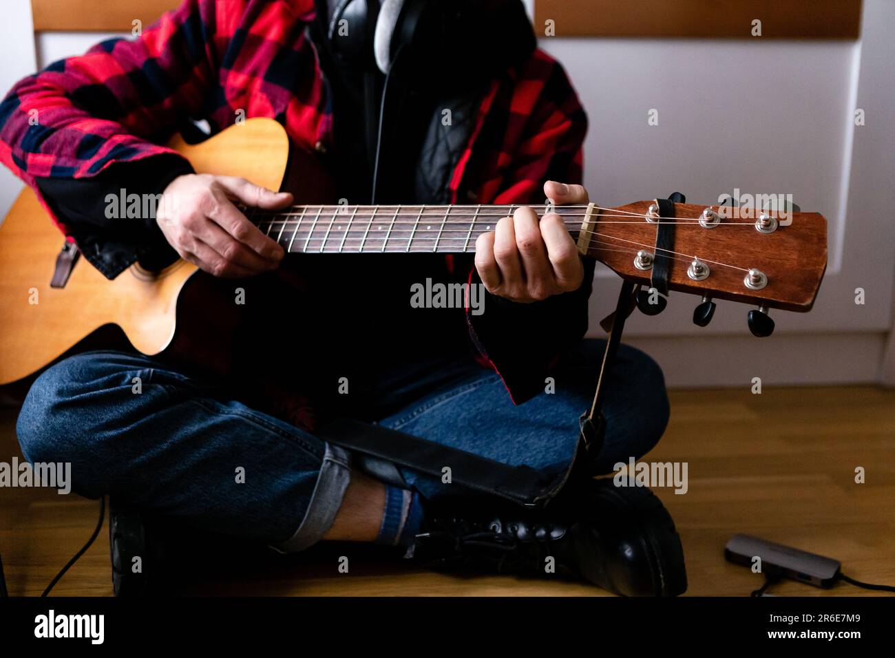 musician in a checkered red shirt plays the guitar alone Stock Photo ...