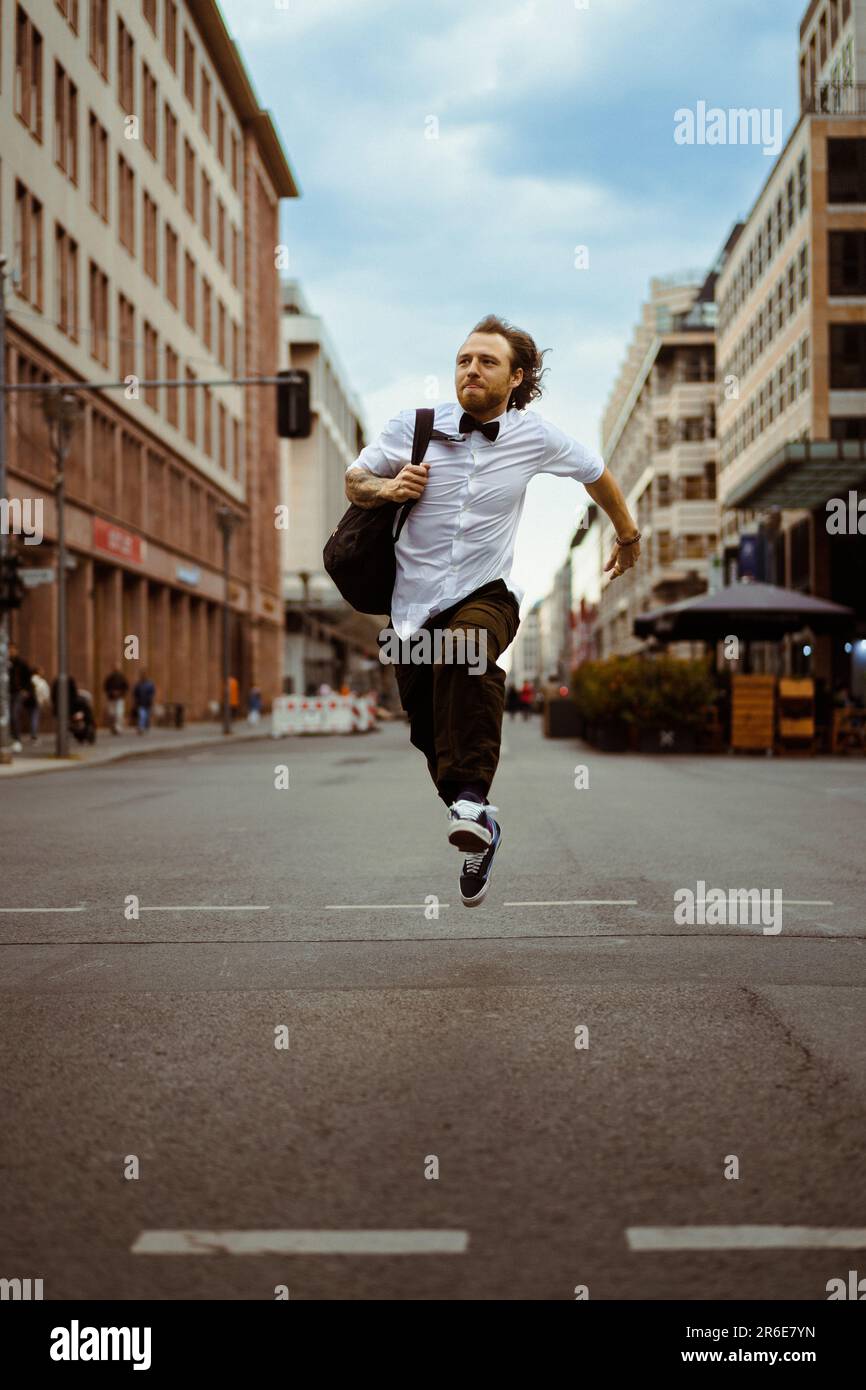 Young happy man running tie hi-res stock photography and images - Alamy