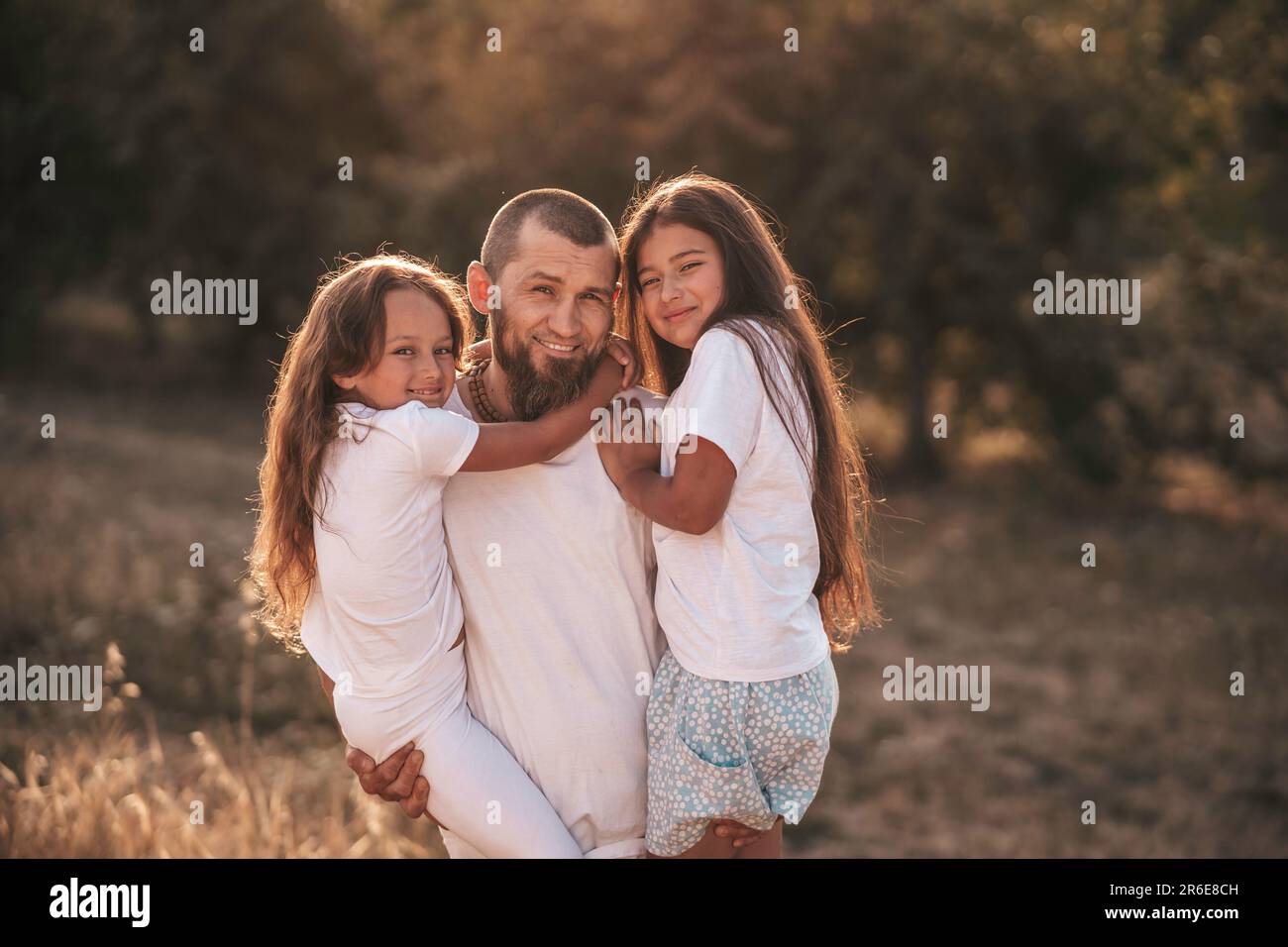 Daddy and two daughters , country life Stock Photo - Alamy