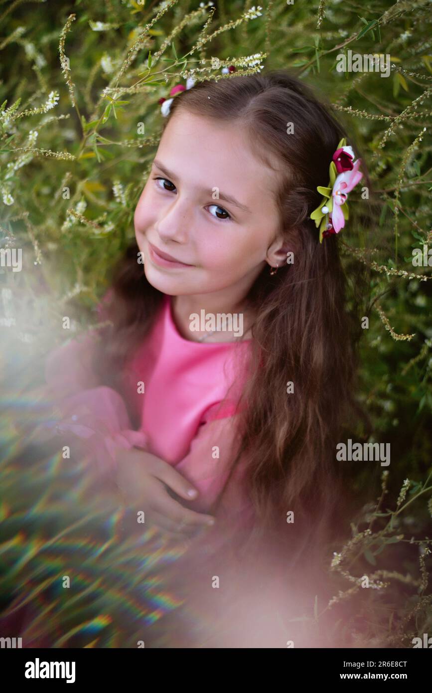 Little girl in pink dress looking at eat camera Stock Photo - Alamy