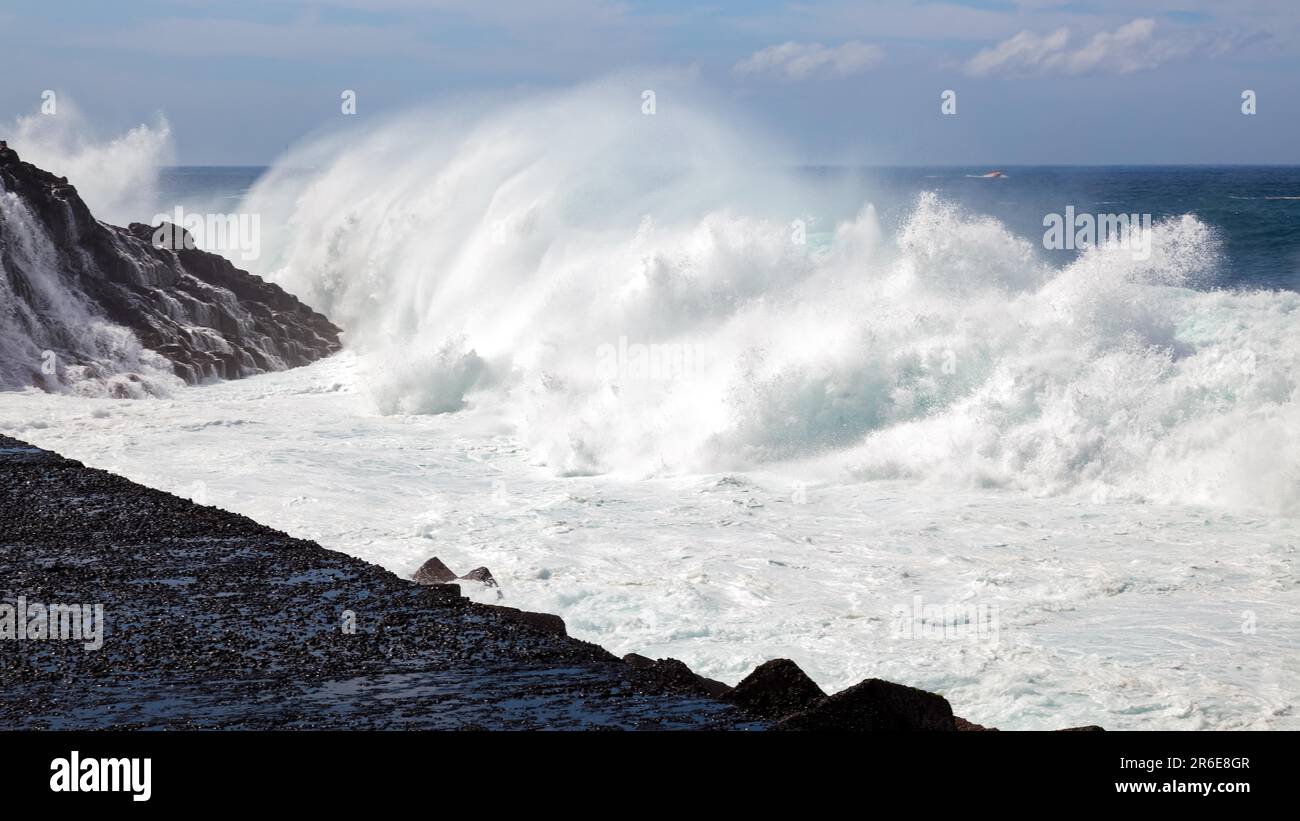 Massive wave hitting the rocky shore in Tenerife Stock Photo - Alamy