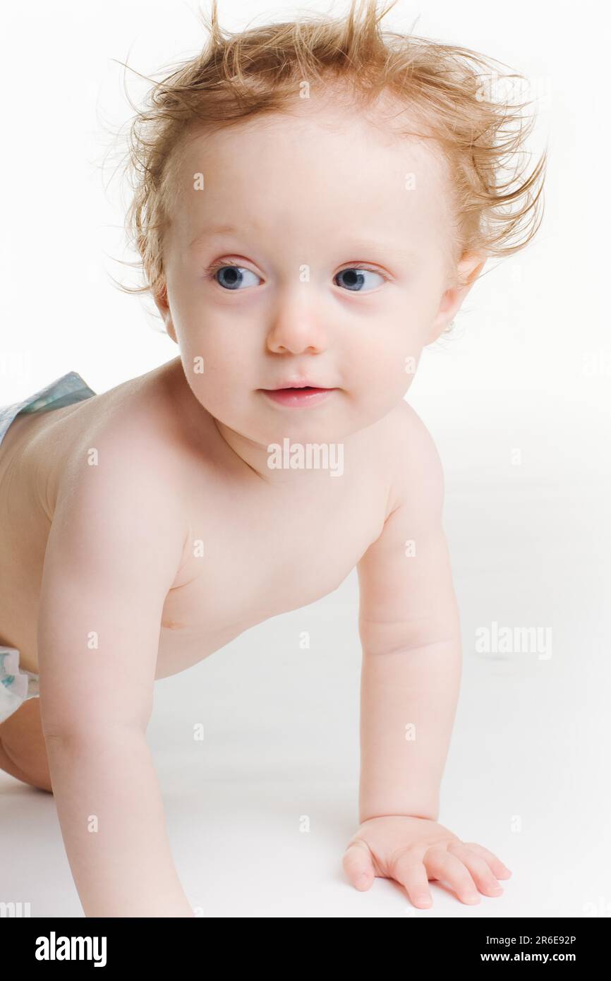 Cute baby in nappy crawling on white background Stock Photo - Alamy