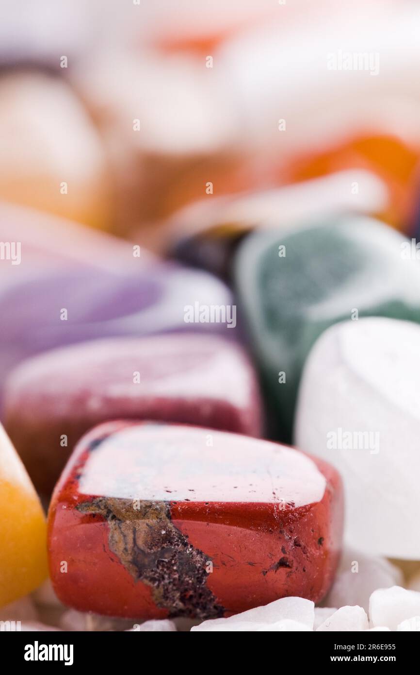 Many different natural stones in beautiful colours on a white ...