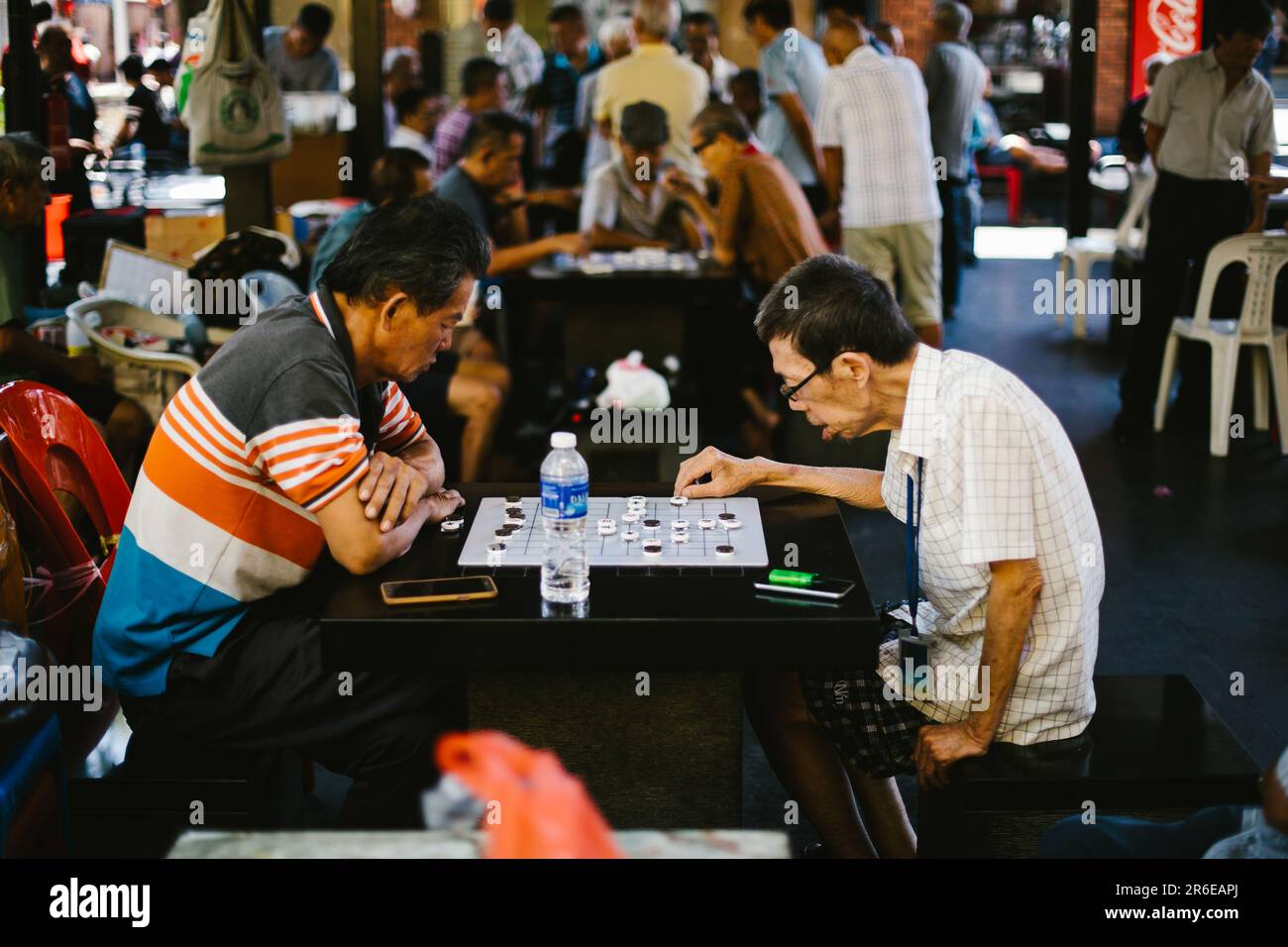 Two men play checkers in busy food market in Chinatown Stock Photo - Alamy