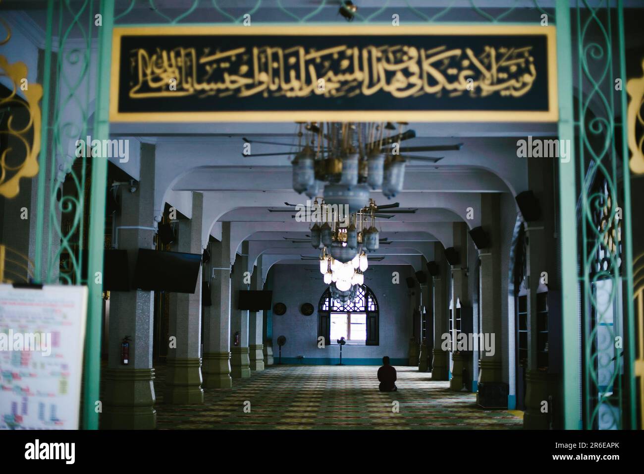 Figure prays in Muslim mosque with side window light Stock Photo - Alamy