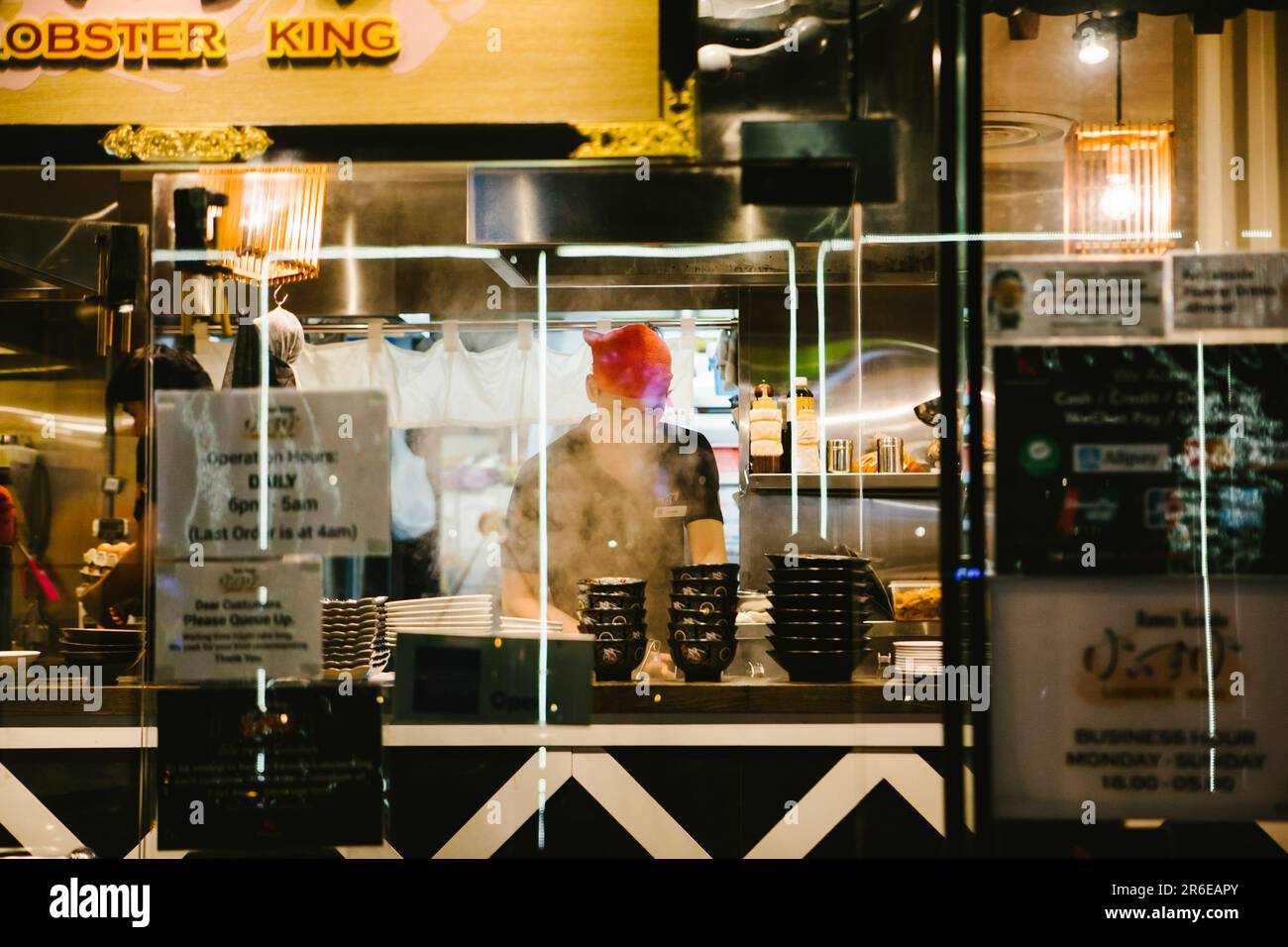 Man and chef cooks on line of restaurant with steam Stock Photo - Alamy