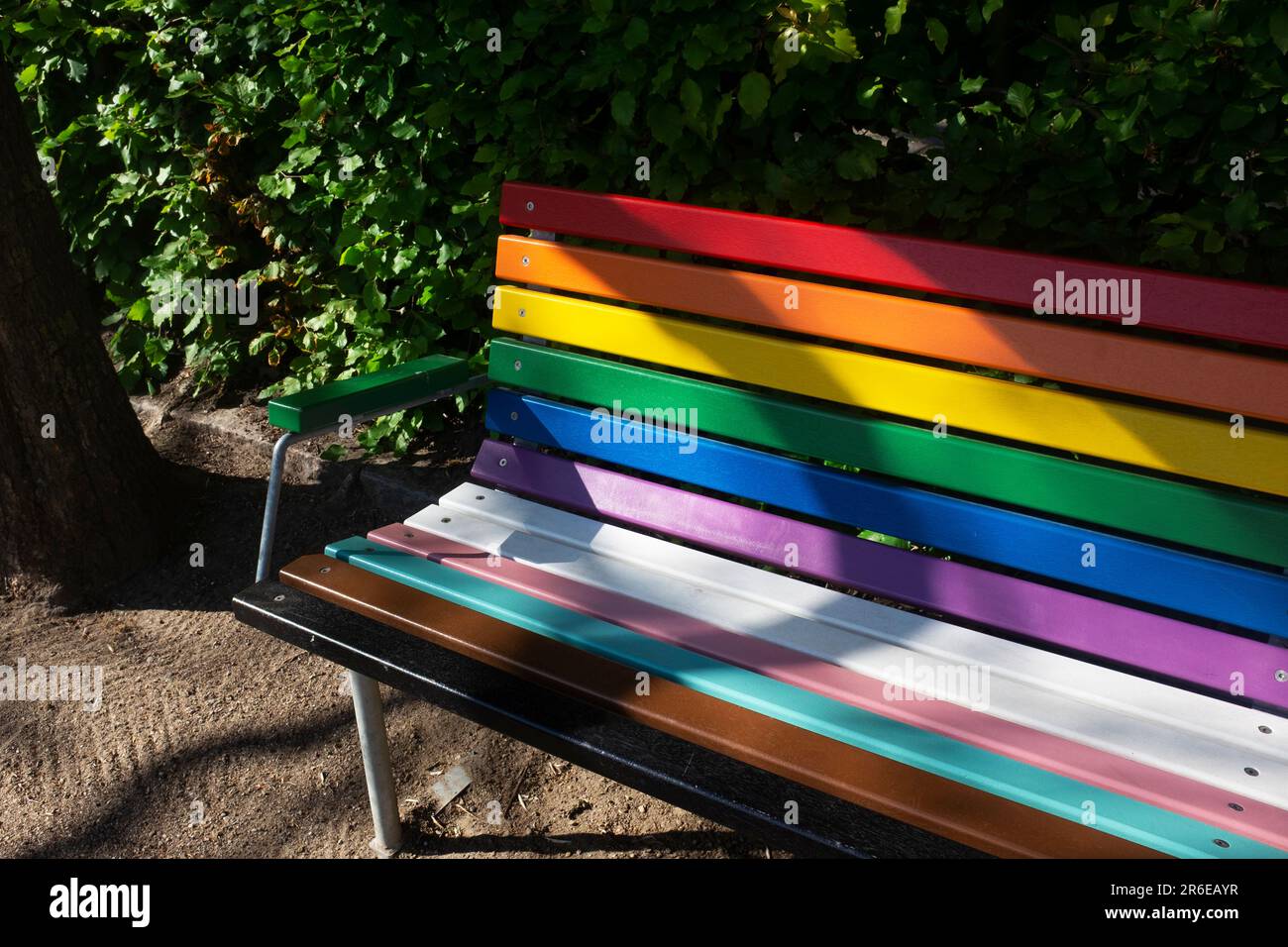 A bench painted with rainbow colours in a park Stock Photo - Alamy