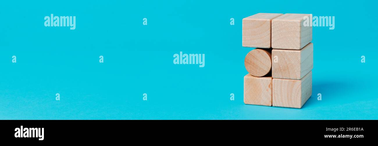 a cylindrical building block in a stack of rectangular building blocks ...