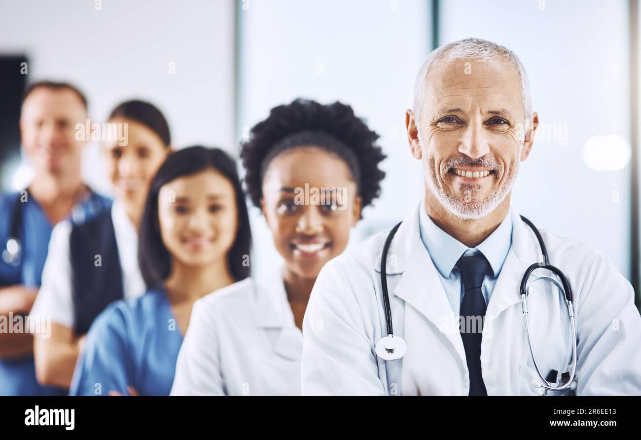 Smile, team and portrait of senior doctor with nurses in hospital ...