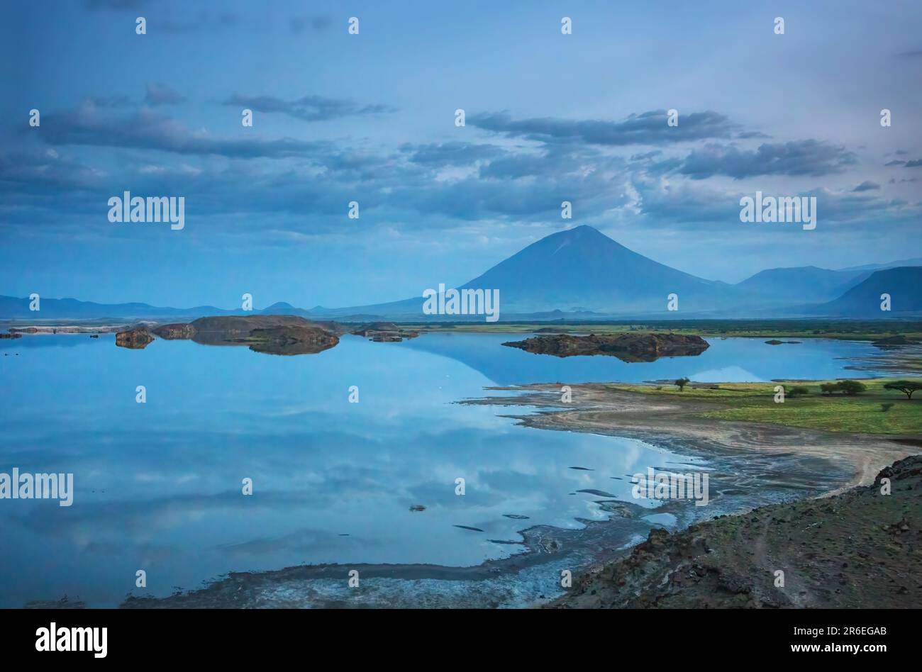 Lake Natron and sacred Masai volcano Ol Doinyo Lengai at dusk. Tanzania ...