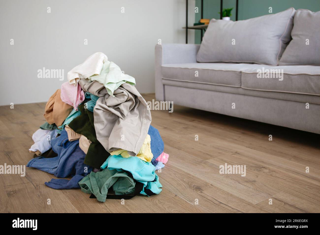 Pile of carelessly scattered clothes on floor Stock Photo - Alamy