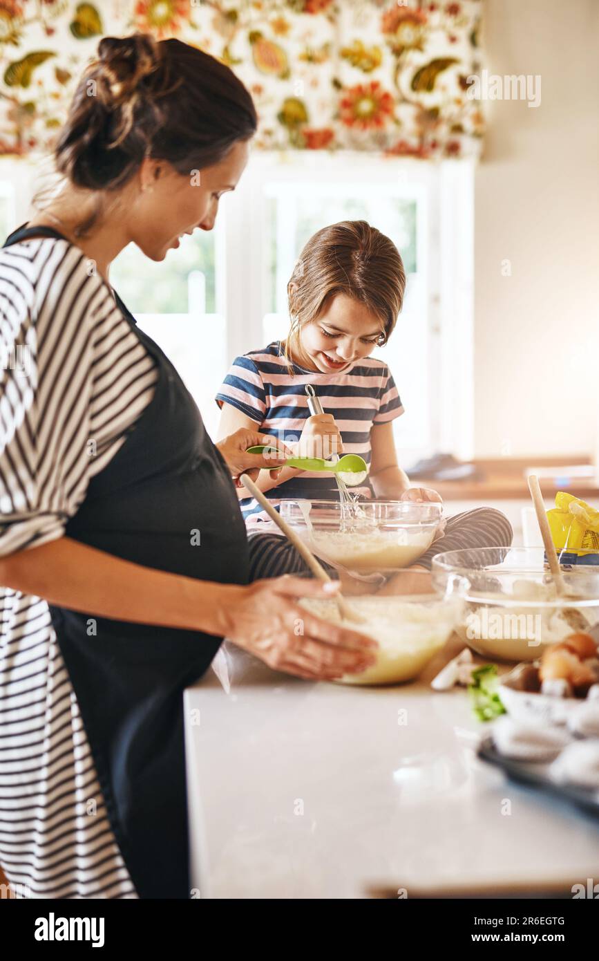 Mother, pregnant or girl baking in kitchen as a happy family with a kid ...