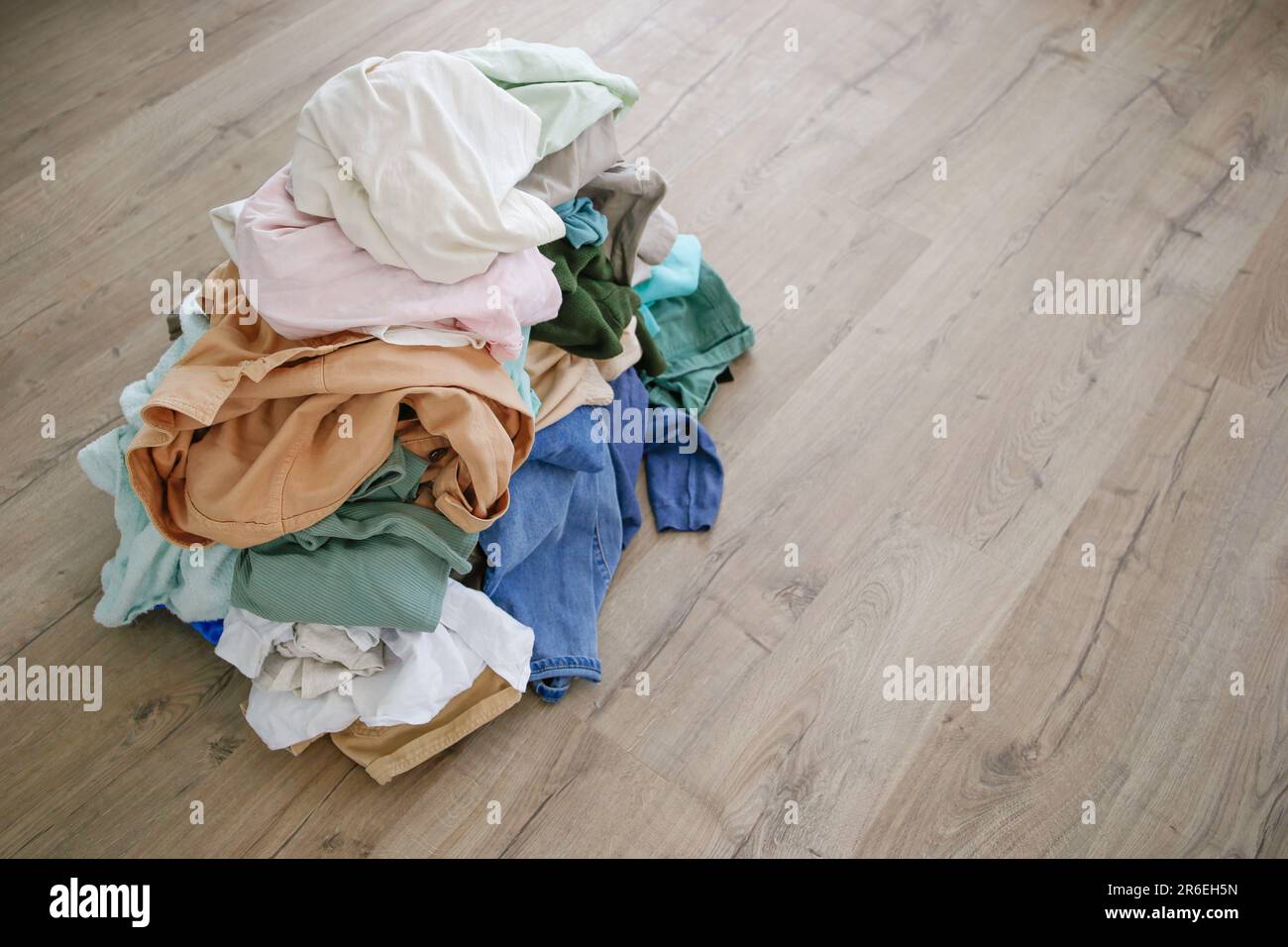 Pile of carelessly scattered clothes on floor Stock Photo - Alamy