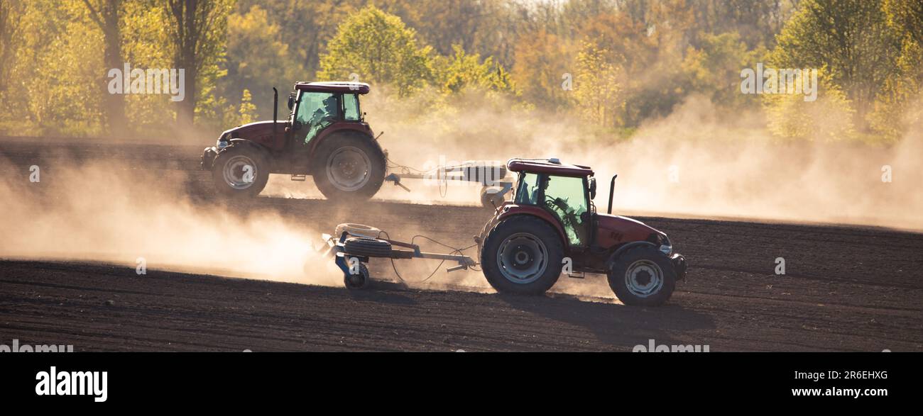 With the help of a sturdy tractor, a cultivator breaks up the soil ...