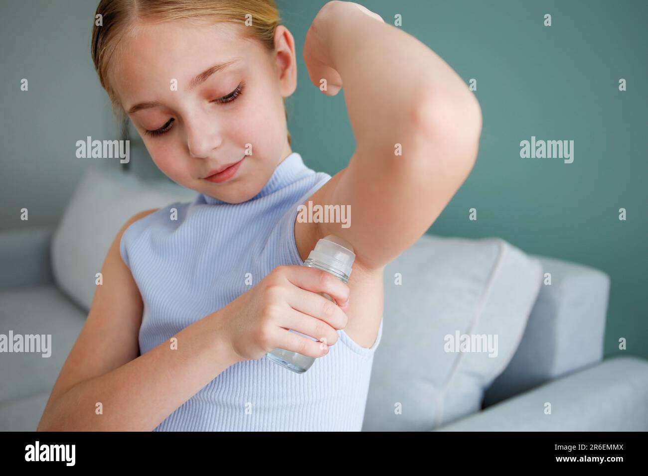 The child uses a ball deodorant. Sweat protection Stock Photo - Alamy