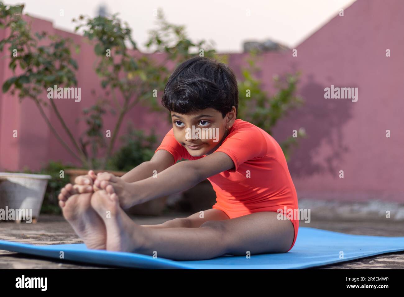 An Indian girl child practicing yoga on yoga mat outdoors Stock Photo ...