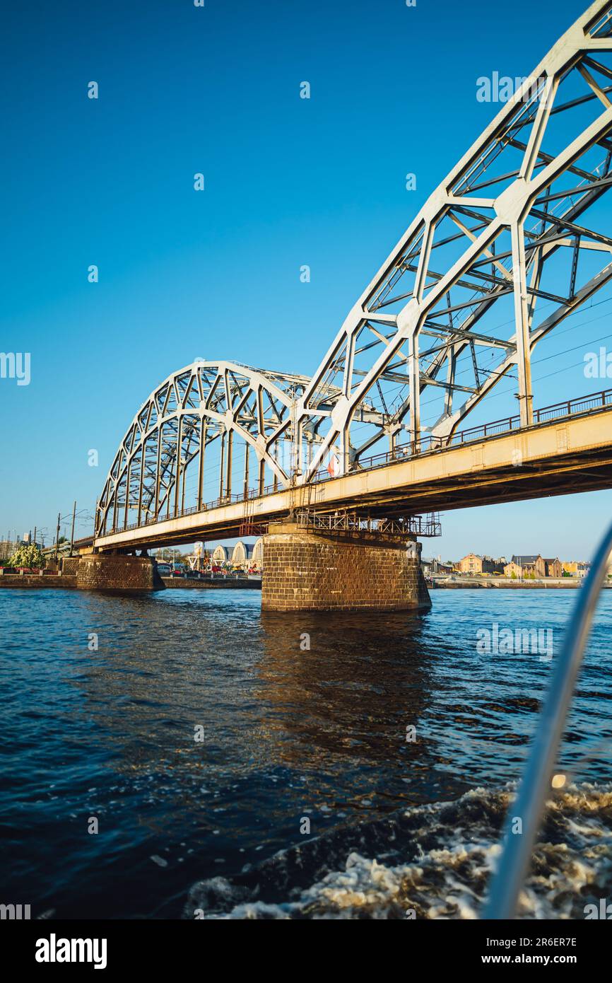 A majestic bridge made of metal spans a picturesque body of water ...