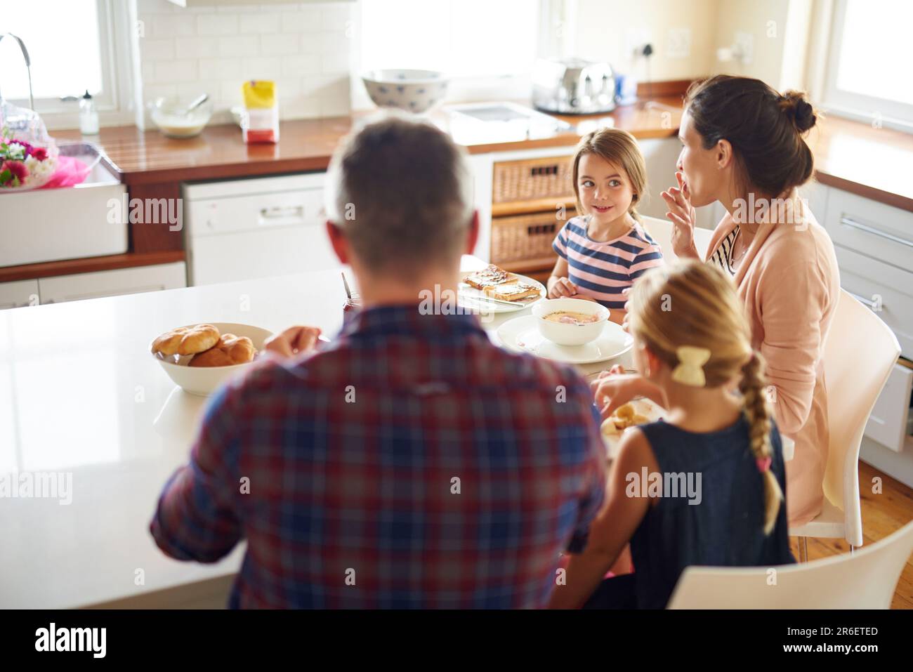 Happy family, morning and eating breakfast on kitchen for meal or ...