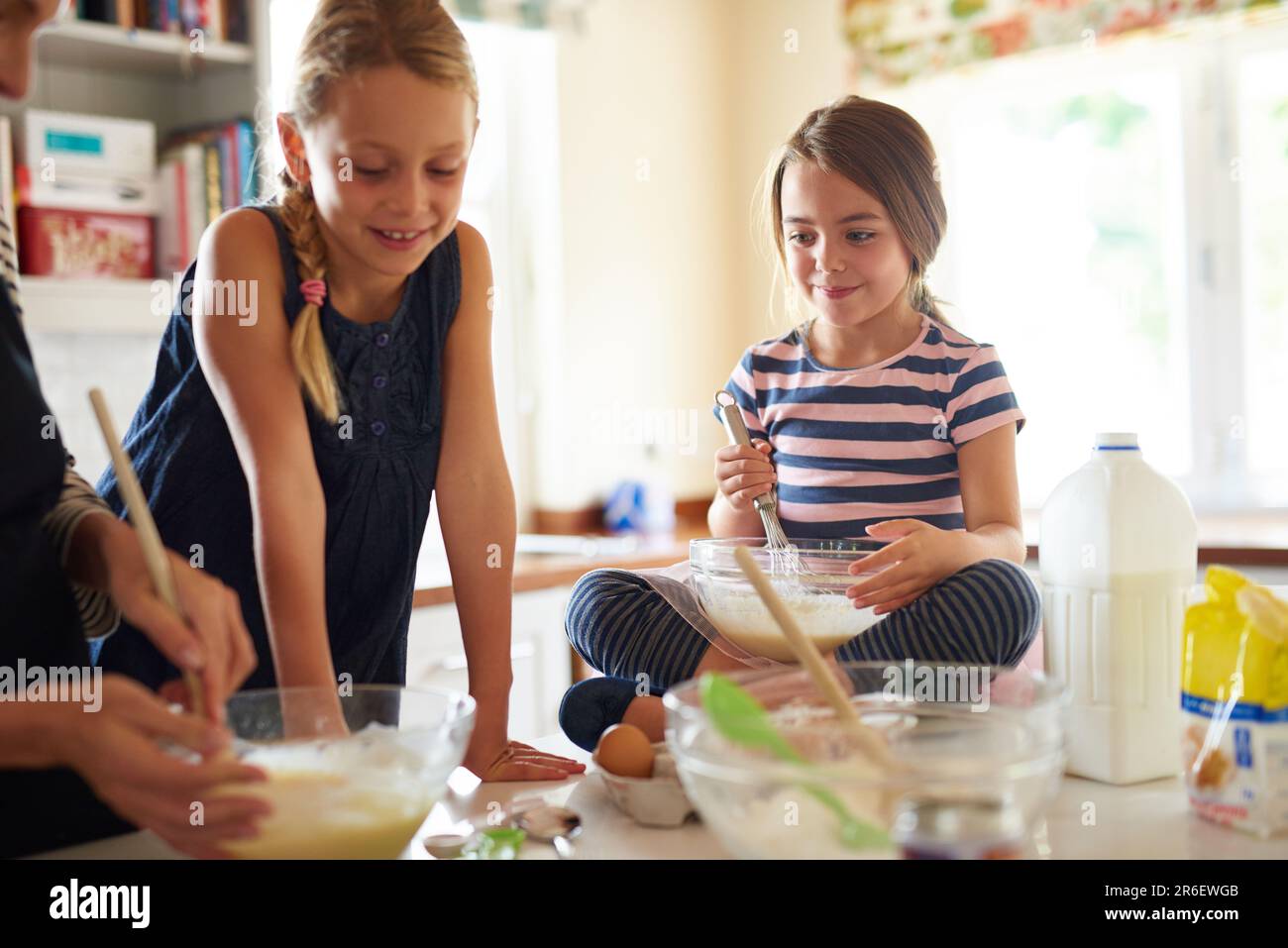 Mother, teamwork or happy kids baking in kitchen as a family with ...