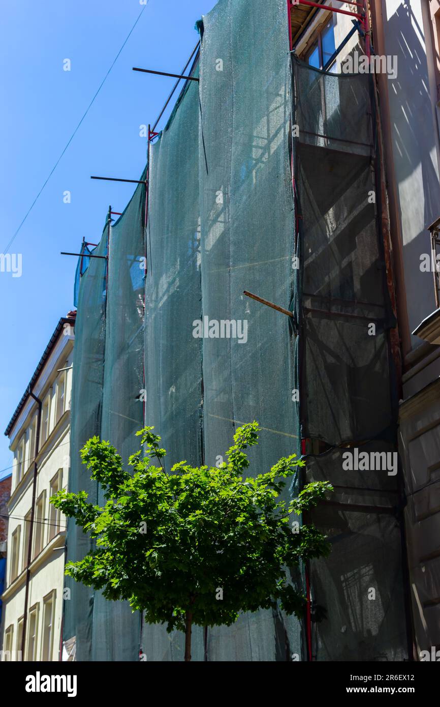 Restoration of the building. Scaffolding and protective green building ...