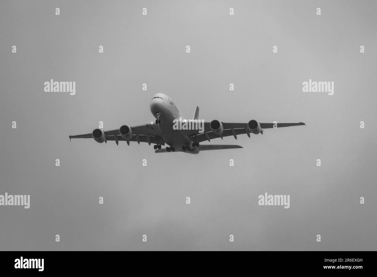 A Lufthansa Airbus 380 Soaring Through The Sky On A Cloudy Day Stock