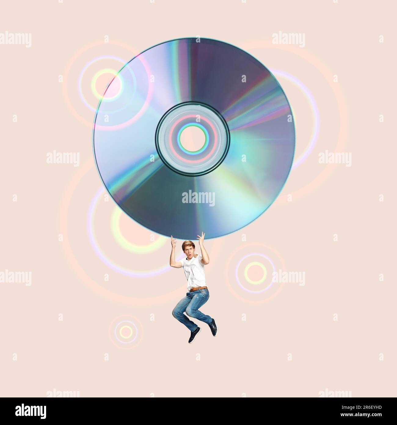 Young man jumping with CD disc over pink background. Party, music ...