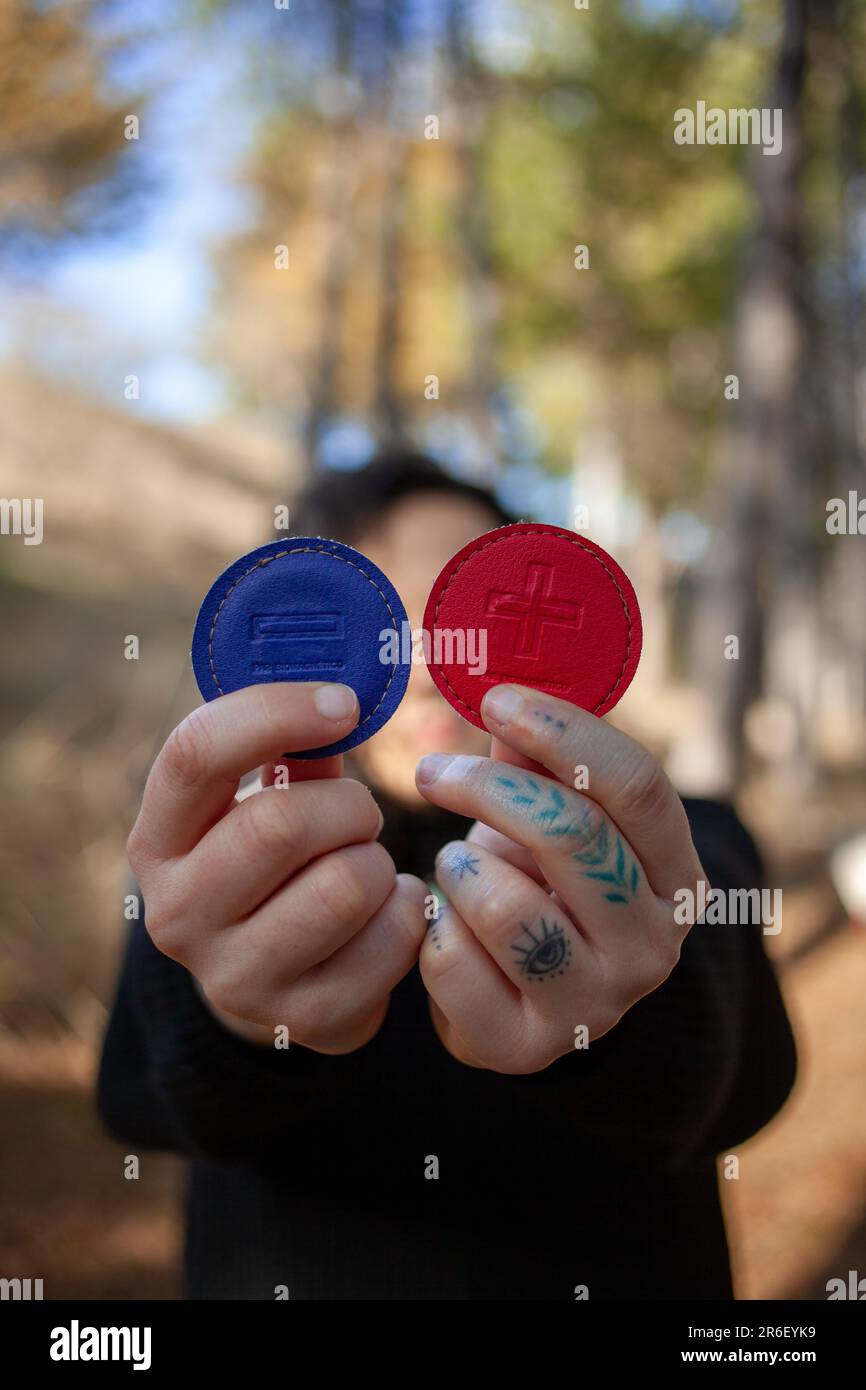 A young woman holding biomagnetism magnets in the forest. Concept of ...