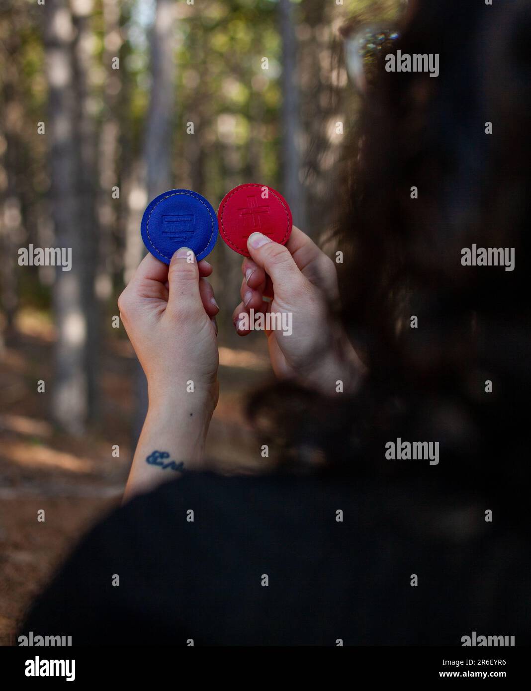 A young woman holding biomagnetism magnets in the forest. Concept of ...