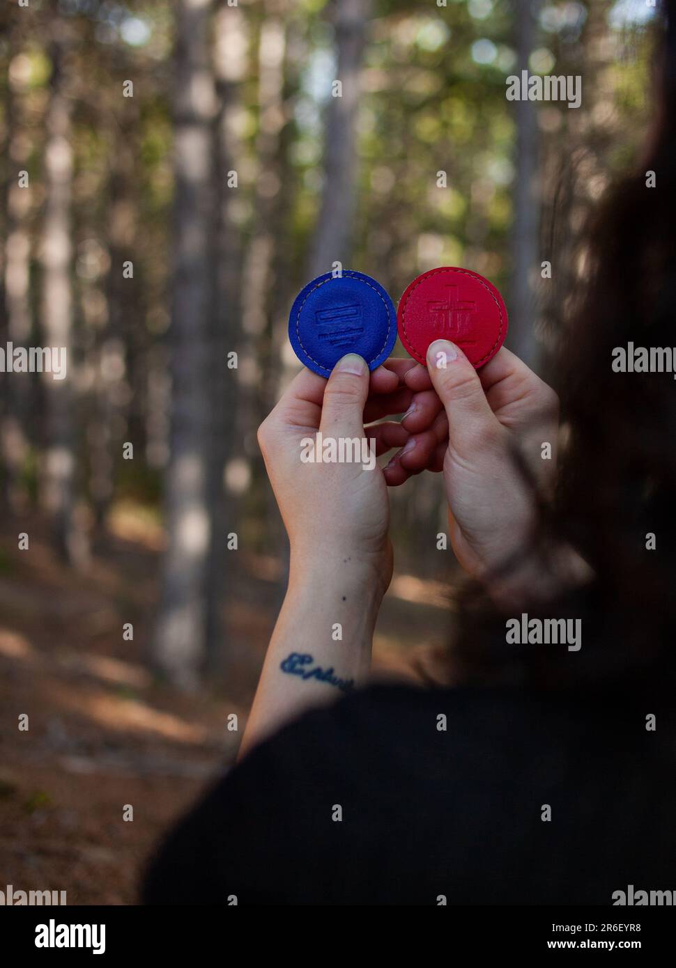 A young woman holding biomagnetism magnets in the forest. Concept of ...
