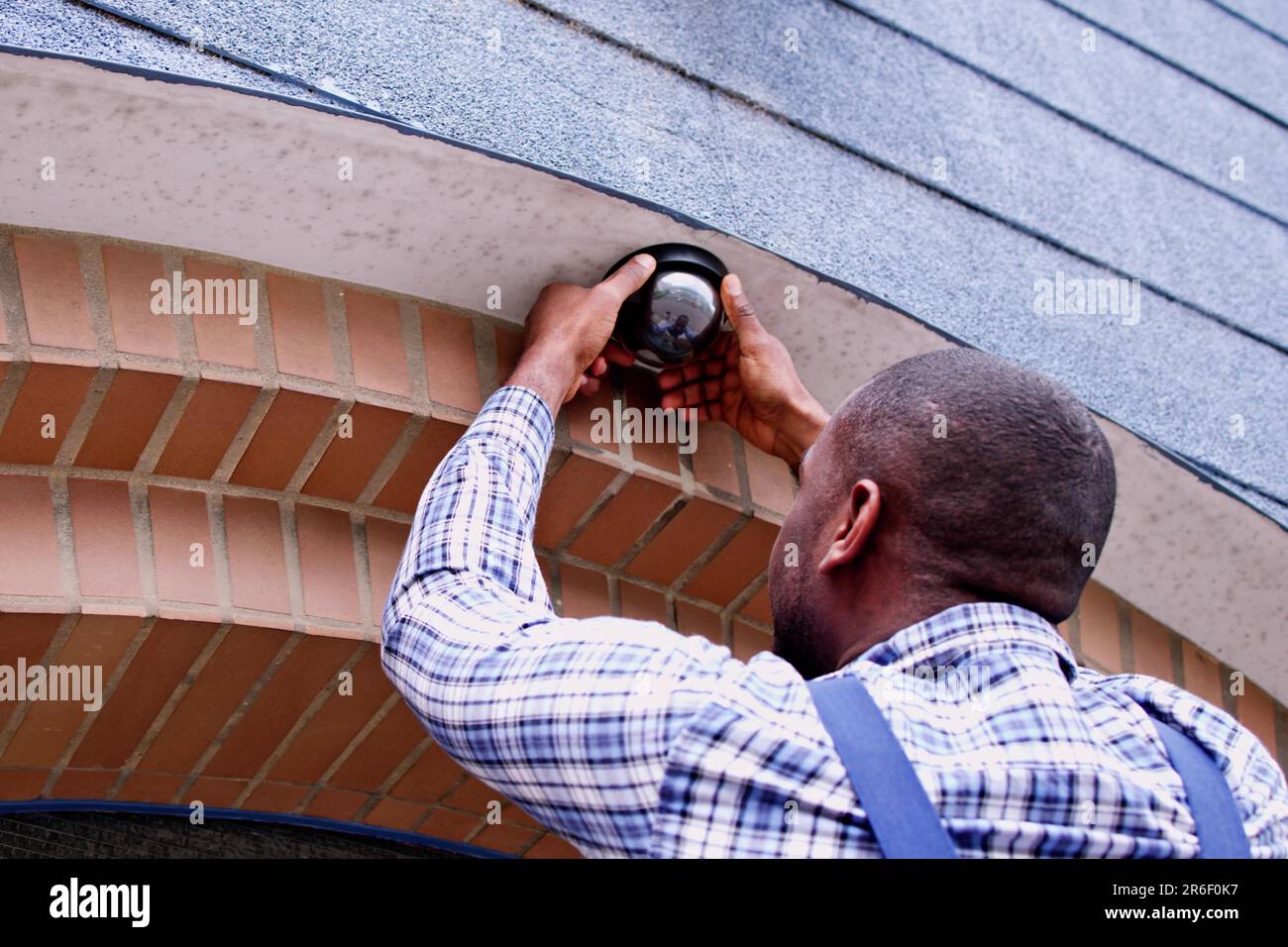 African American Handyman CCTV Camera Installer On Ladder Stock Photo ...