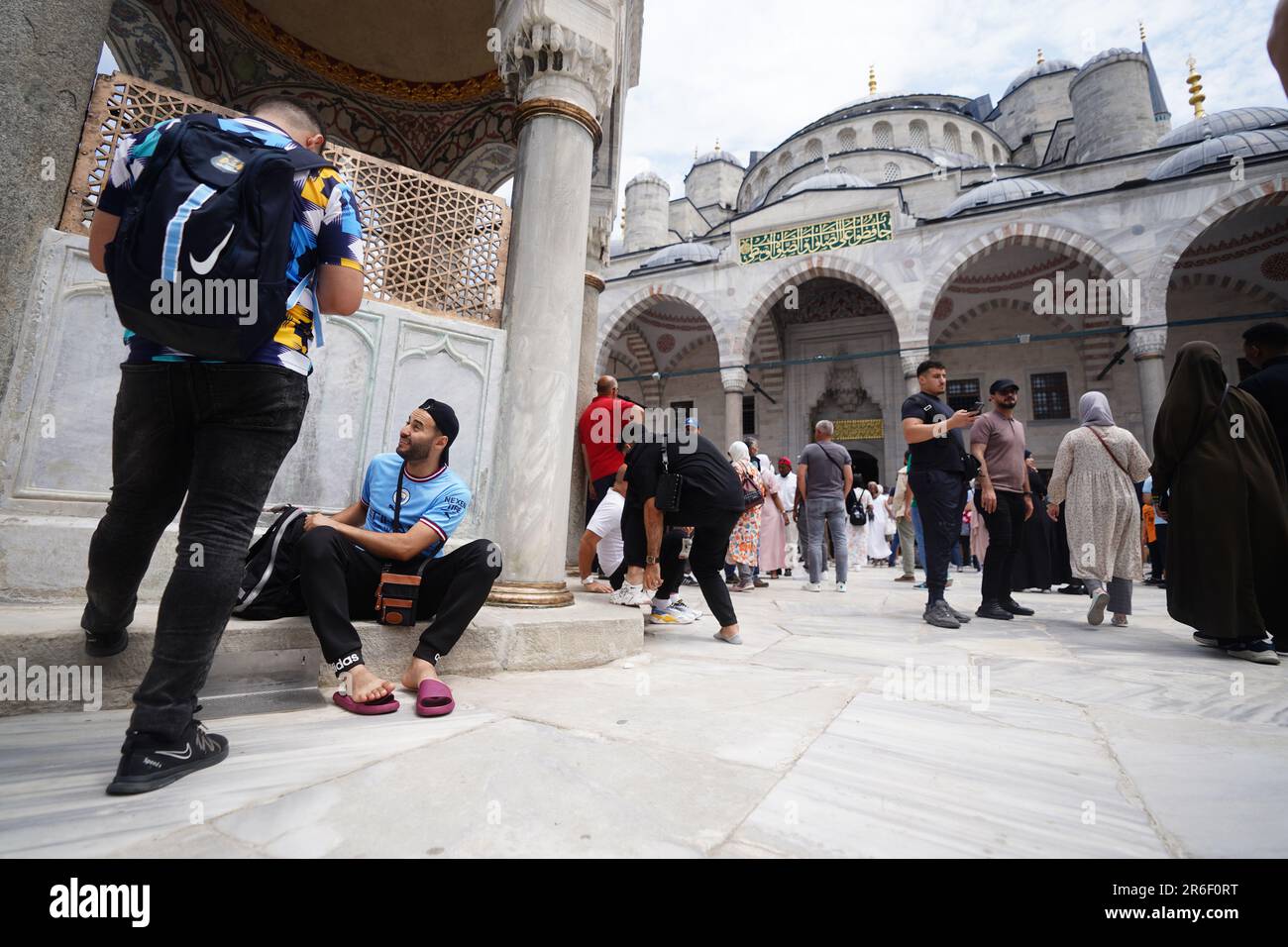 Man City fans take off their shoes before entering the Blue Mosque in ...