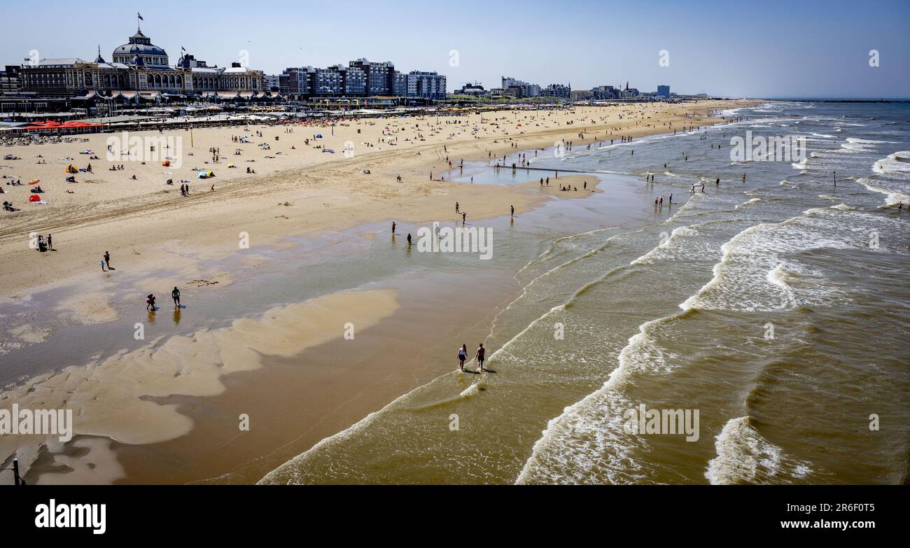 SCHEVENINGEN - Beachgoers enjoy the beautiful weather on the beach of ...